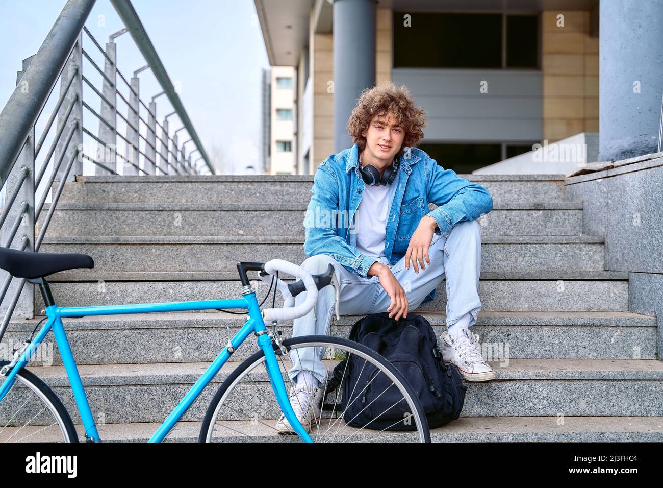 Full body of positive curly haired male in casual clothes with ...