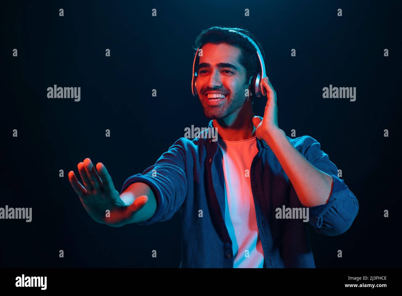 Young man listening music in headphone and looking elsewhere Stock ...