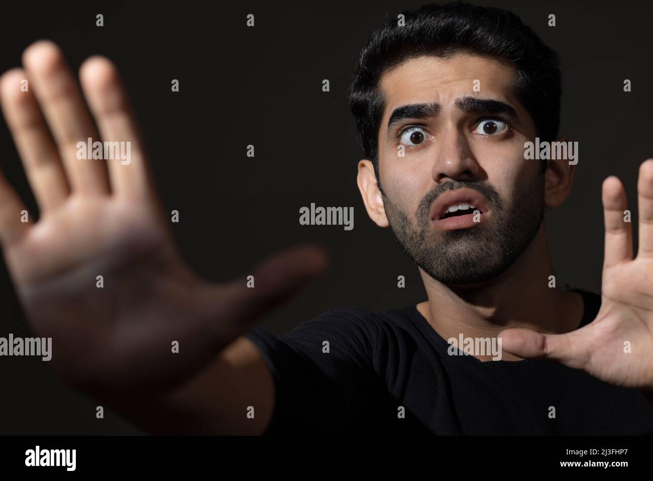 Portrait of a scared young man looking with wide eyes Stock Photo - Alamy