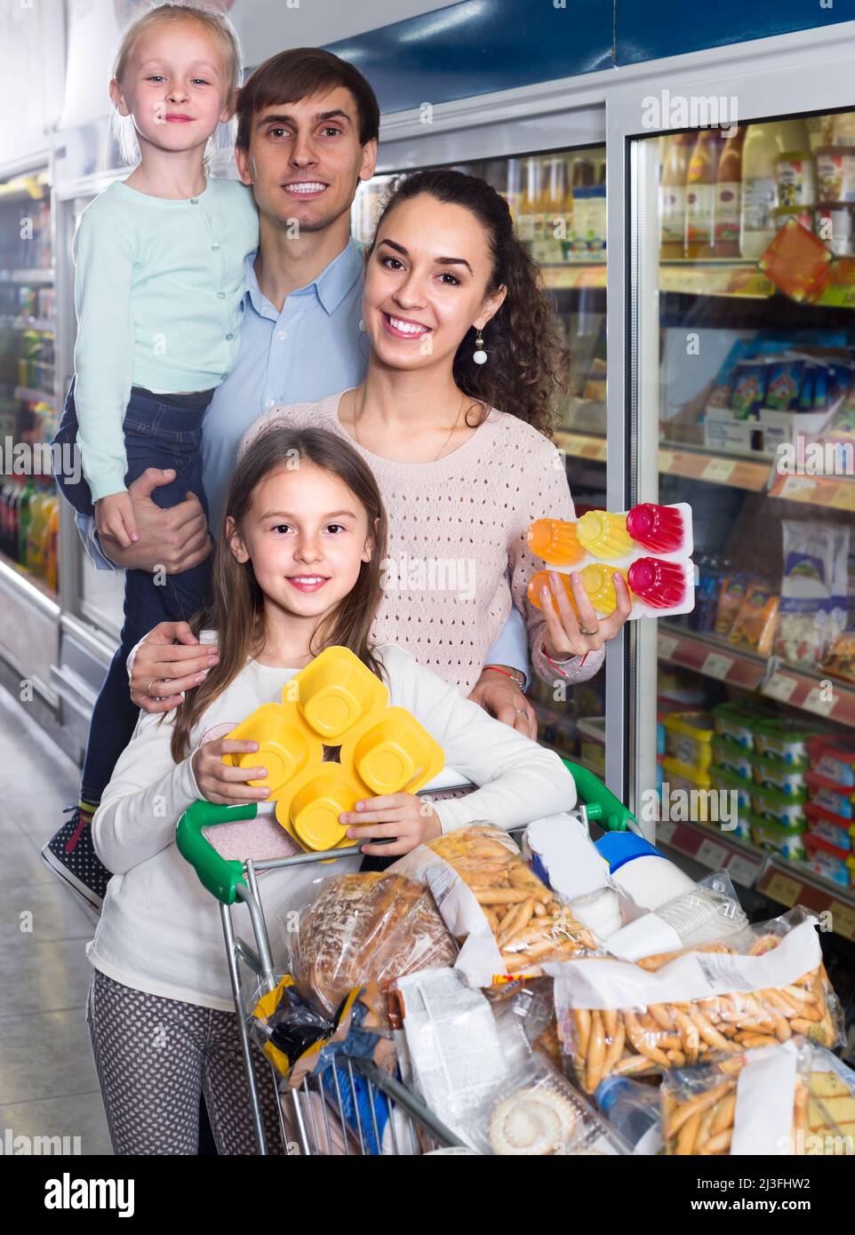 Family purchasing yoghurts in supermarket Stock Photo - Alamy