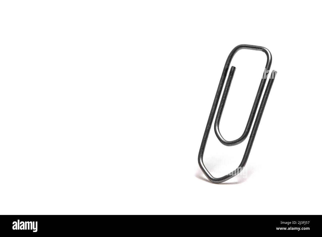 Close up white background with copy space an a steel metal paper clip ...