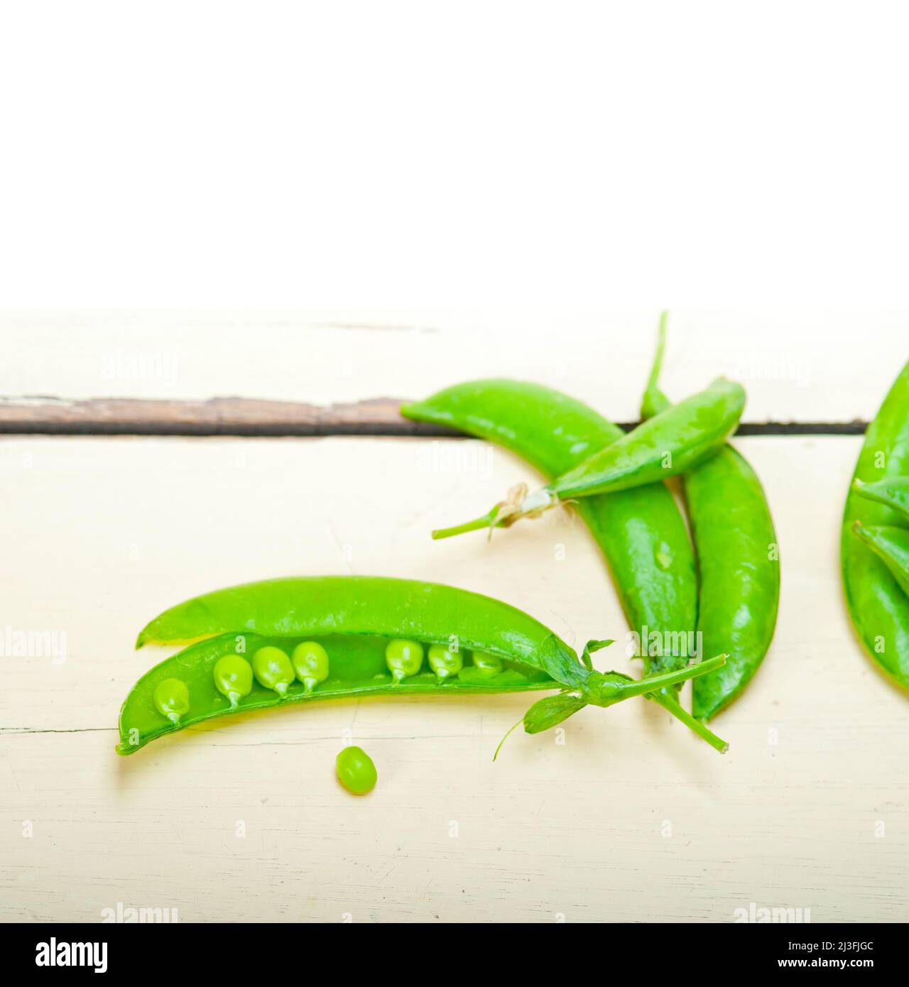 hearthy fresh green peas over a rustic wood table Stock Photo - Alamy