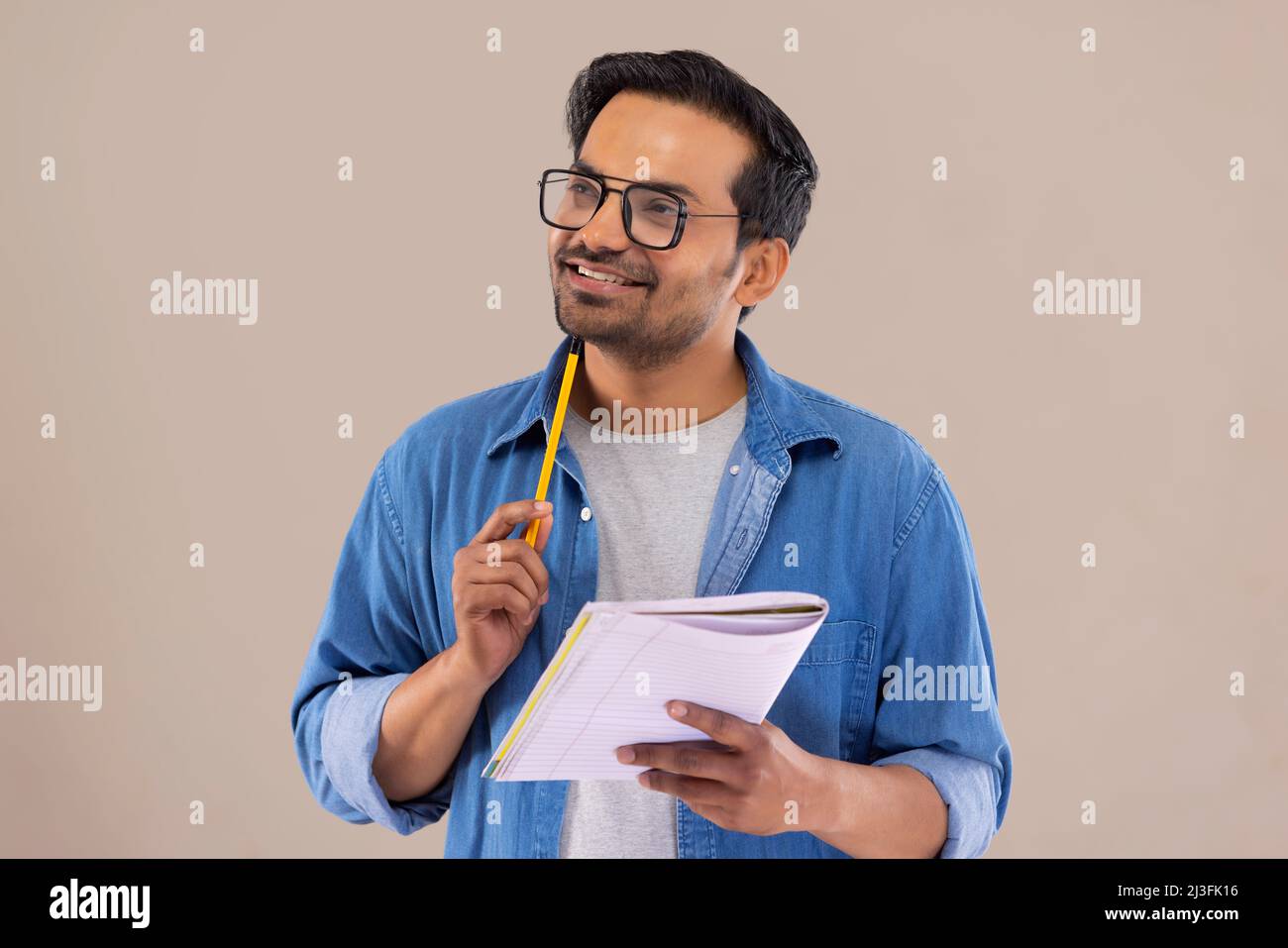 Man with pencil thinking hi-res stock photography and images - Alamy