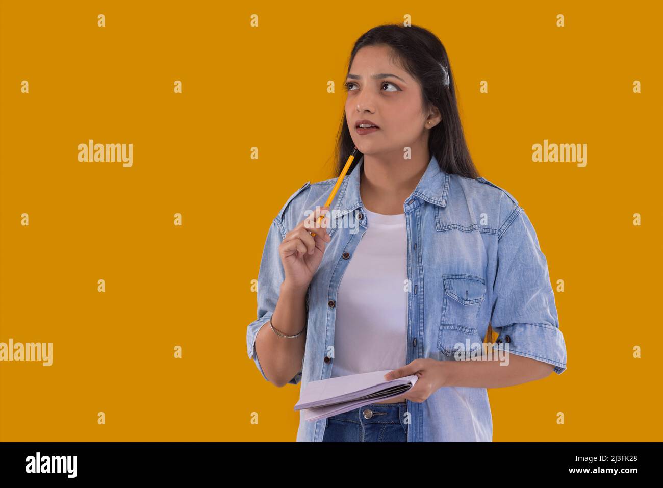 Woman thinking holding pencil hi-res stock photography and images - Alamy