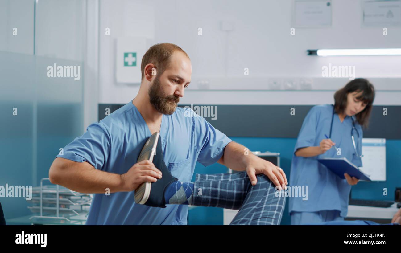 Health therapist cracking legs bones and stretching muscles, treating ...