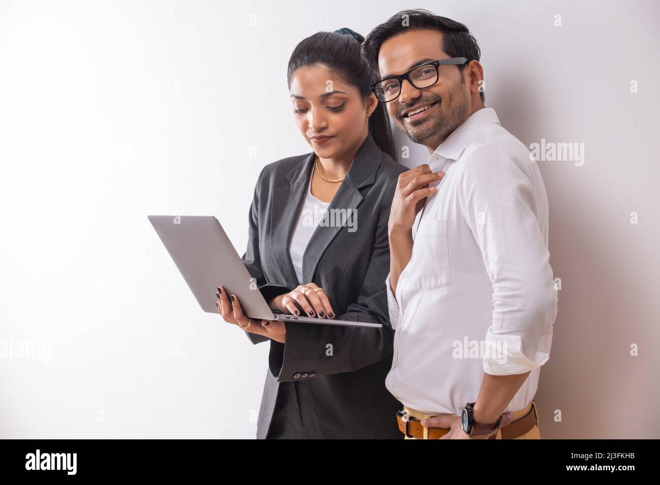 Office colleagues together doing office work using laptop Stock Photo ...
