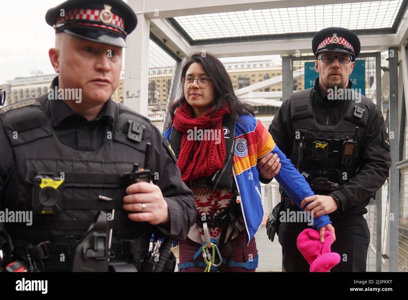 Police officers bring on shore an activist from Extinction Rebellion ...