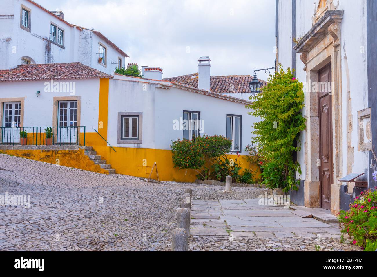 View of a narrow street inside of the obidos castle in Portugal Stock ...