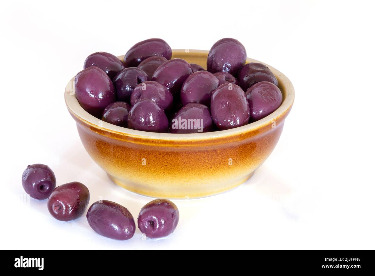 purple olives in a bowl isolated on a white background Stock Photo - Alamy