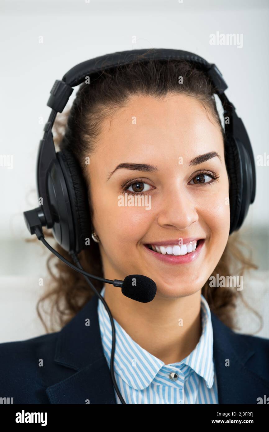 Happy woman call center operator talking with client Stock Photo - Alamy