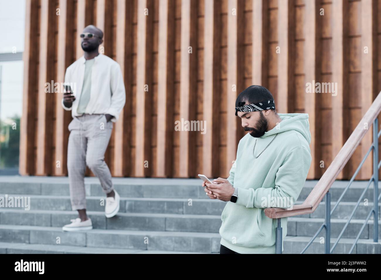 Middle eastern guy reading messenger chat while black man using phone ...