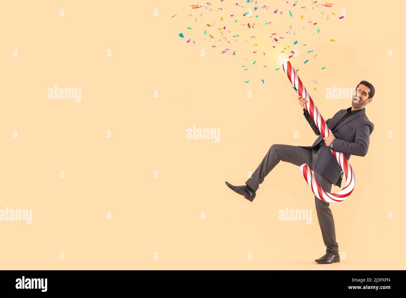 Happy businessman dancing with candy cane Stock Photo - Alamy
