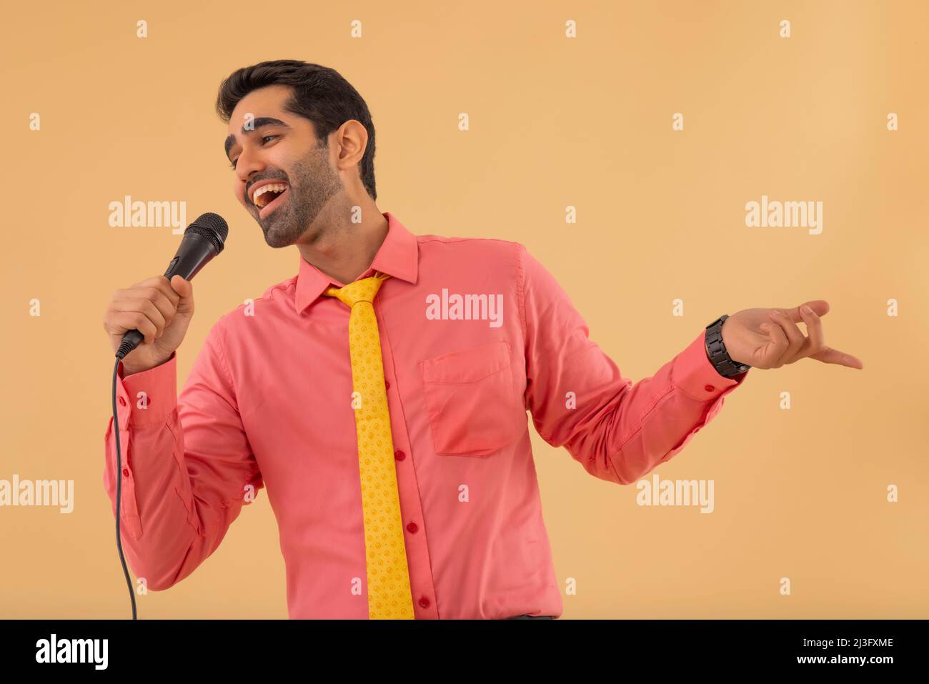 Happy corporate man singing on microphone Stock Photo - Alamy