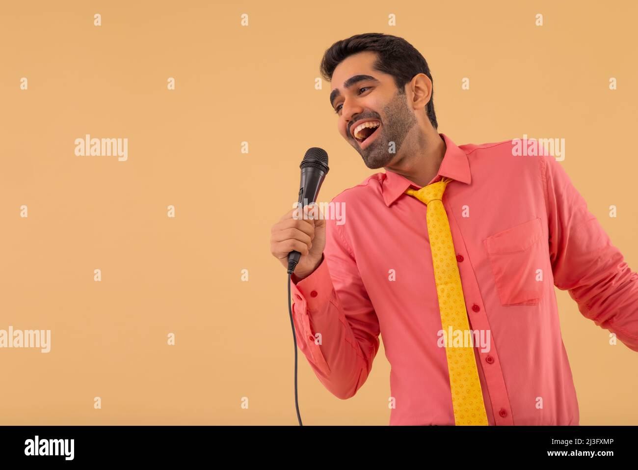 Happy corporate man singing on microphone Stock Photo - Alamy