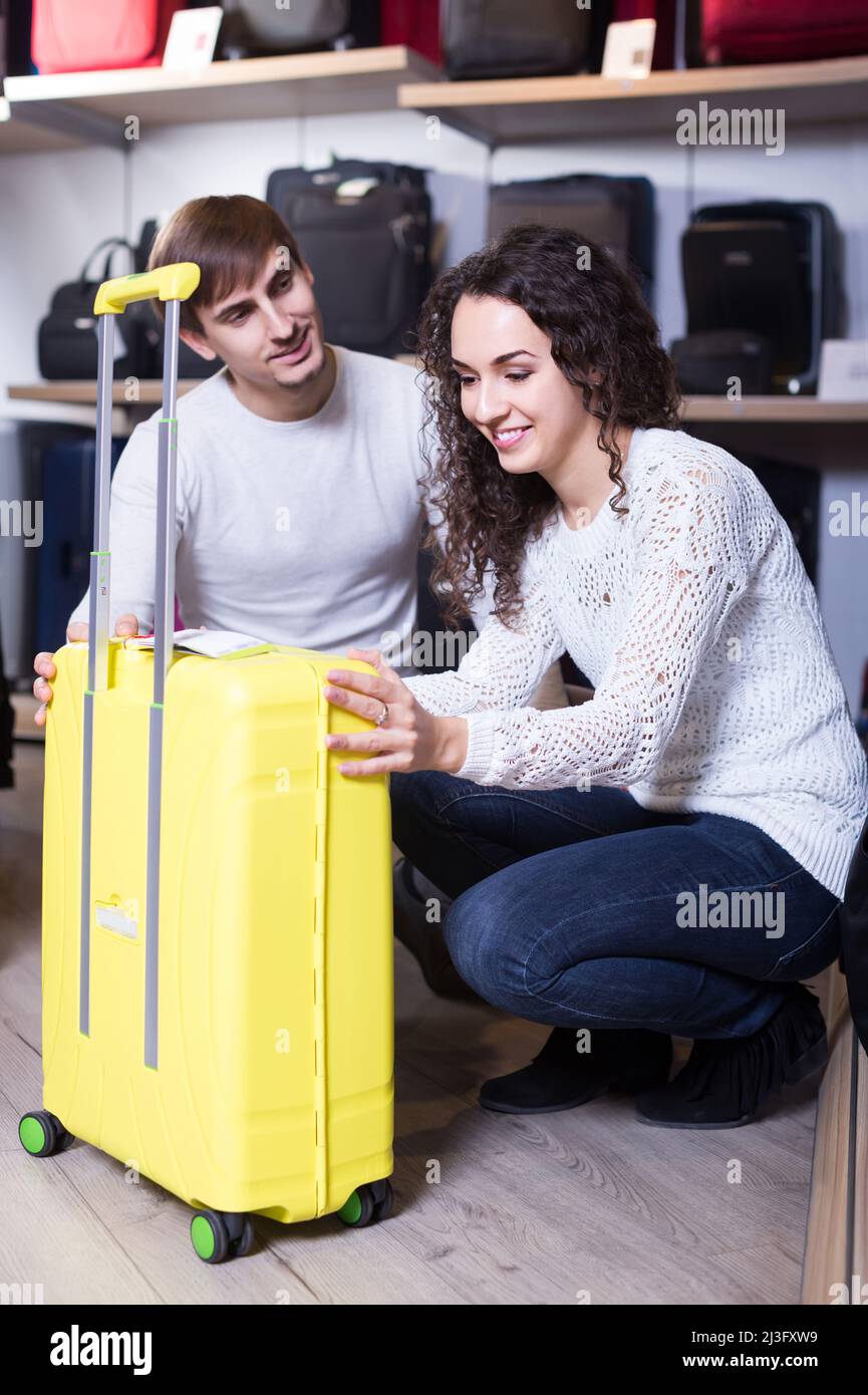 customers looking at roll-aboard bags in store Stock Photo - Alamy