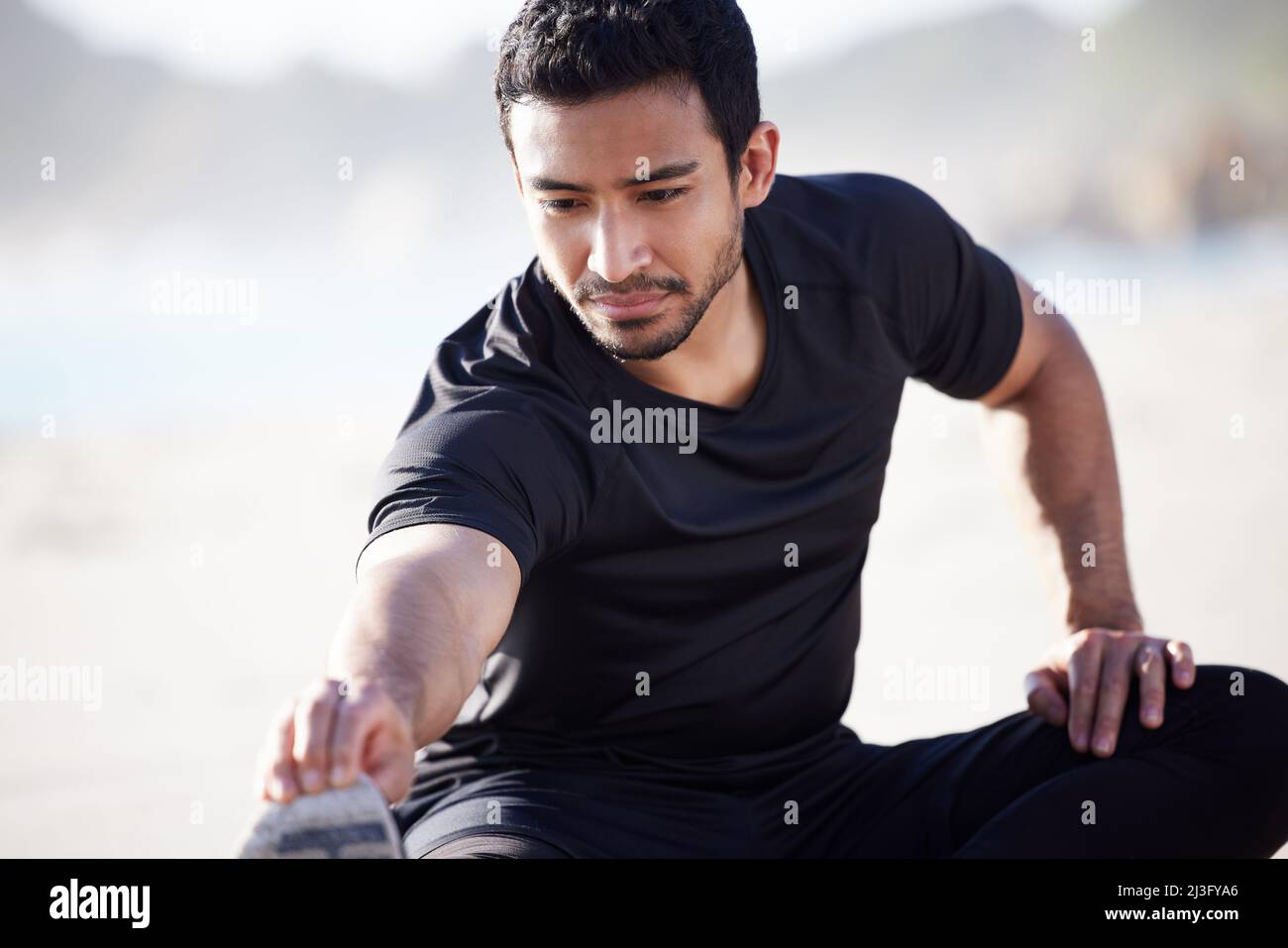 Getting his body ready for a workout. Cropped shot of a handsome young ...