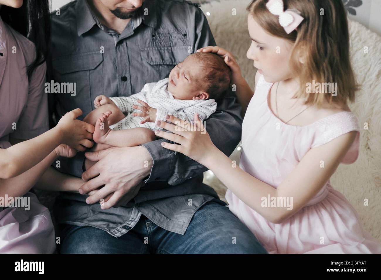 Newborn father holding baby sister family sibling hi-res stock ...