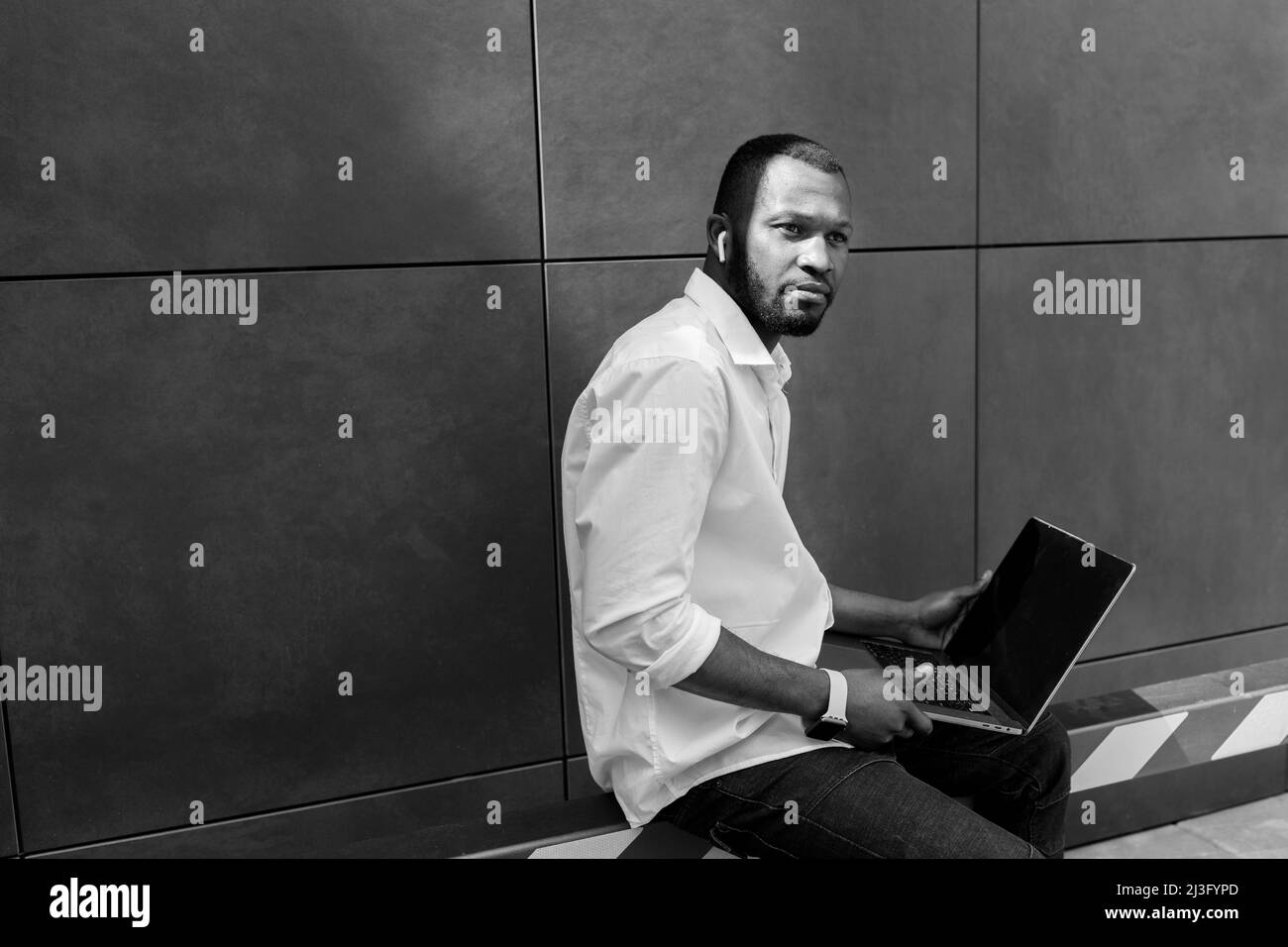 Portrait man holding computer Black and White Stock Photos & Images - Alamy