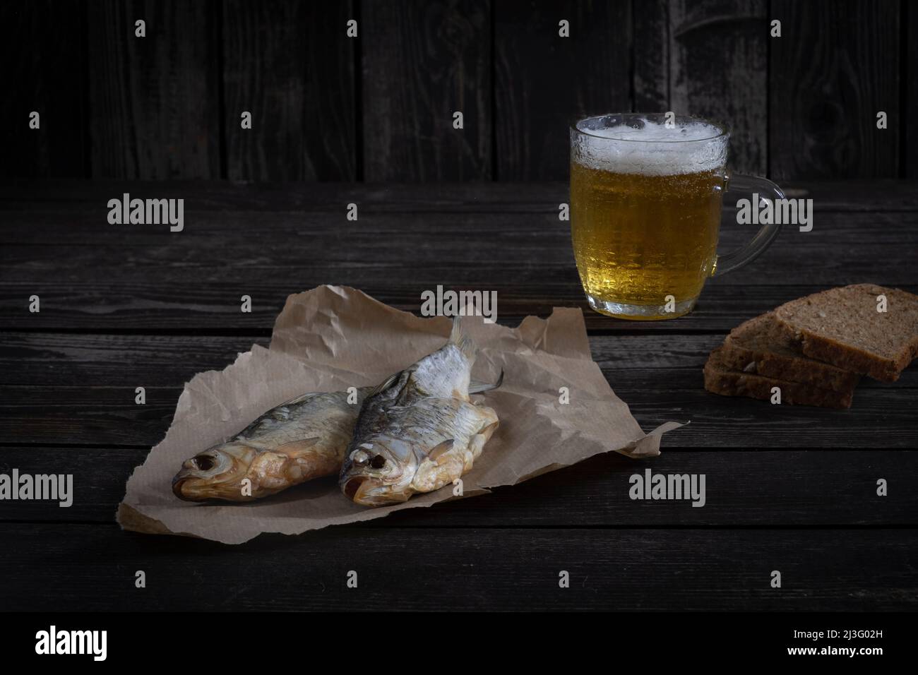 Dried river fish, Snacks for beer on dark wooden background with rustic ...