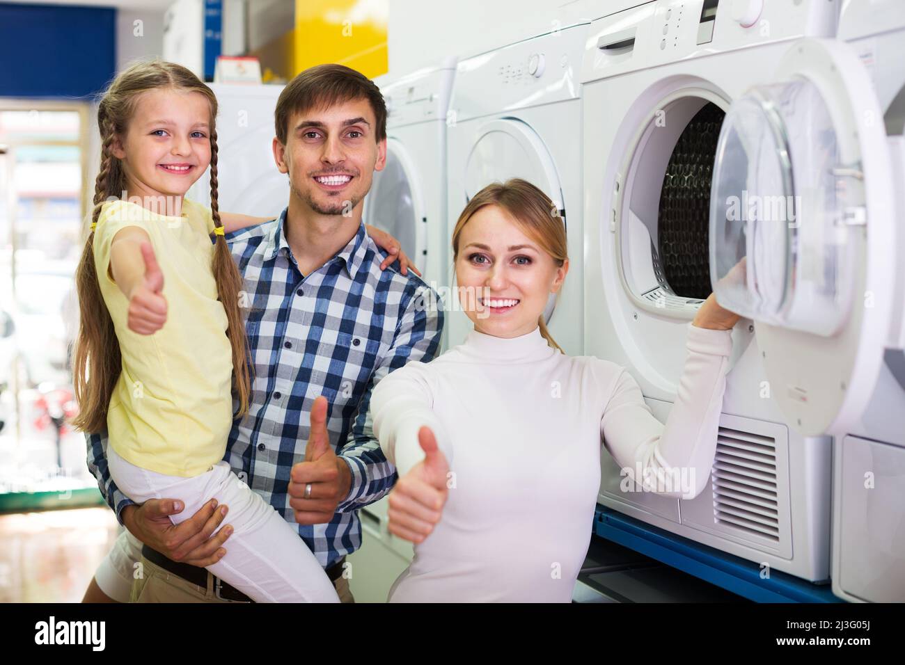 Family choosing washing machine Stock Photo - Alamy