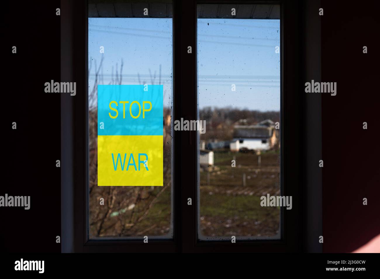 Flag of Ukraine on the window sealed with tape. No war. War in Ukraine ...