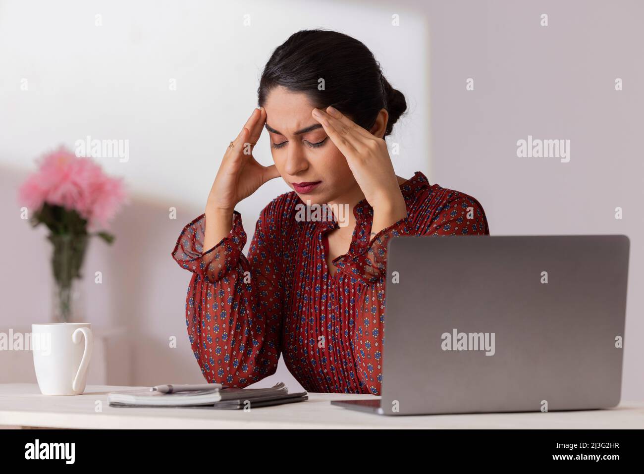 Portrait of an exhausted working woman with laptop in office Stock ...