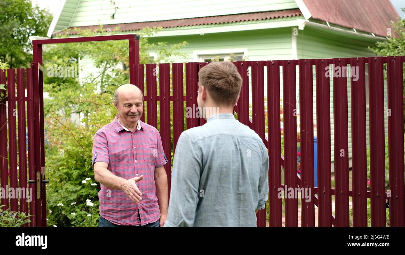 two farmers shaking hands and talking to each other on sunny day. I am ...