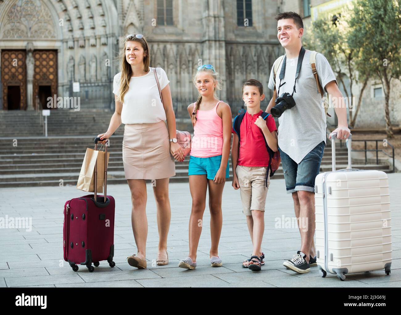 Happy parents with children travelling together on city Stock Photo - Alamy