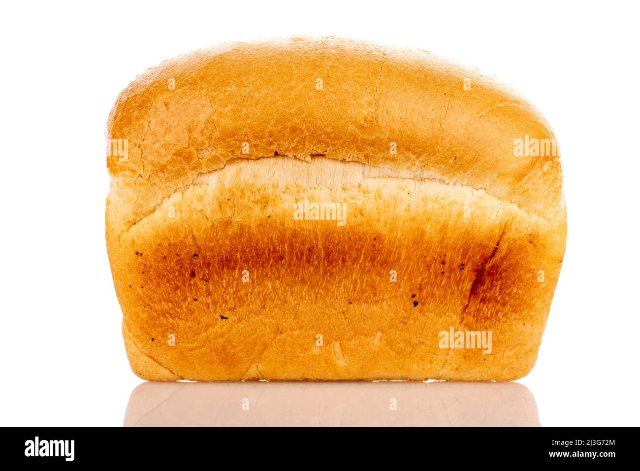 One loaf of fresh fragrant white wheat bread, macro, isolated on a ...