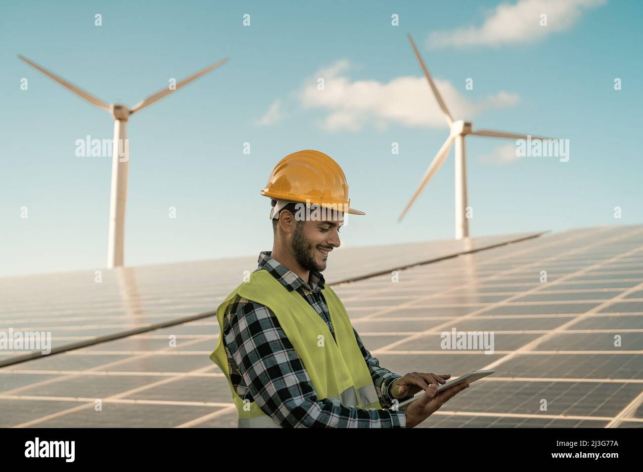 Young engineer watching on digital tablet the new green plan for ...