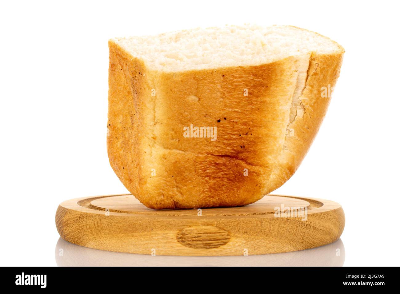 One half of a loaf of flavored wheat bread on a round wooden tray ...