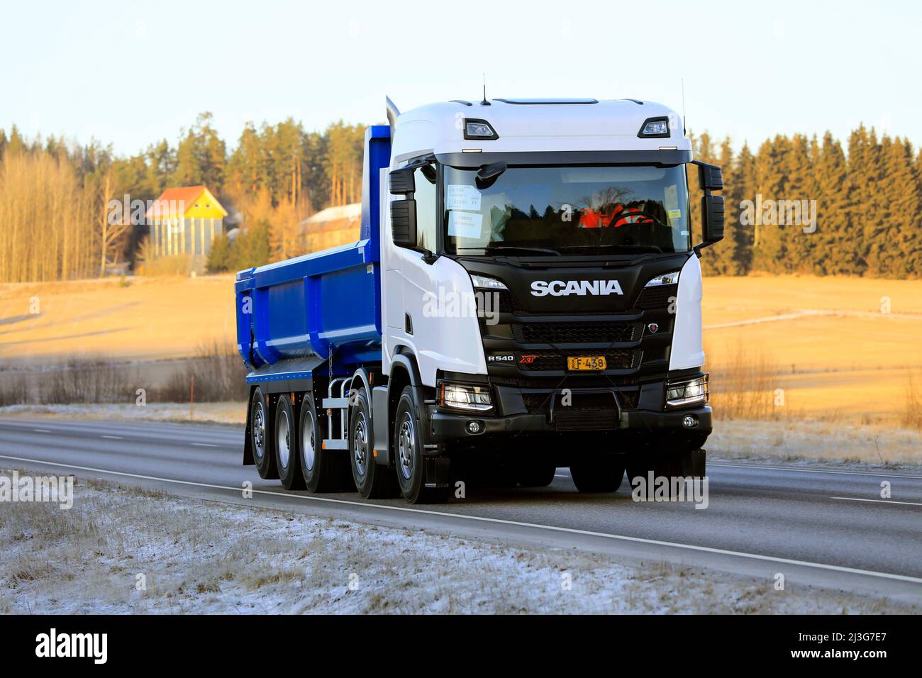 New, white Scania R540 XT tipper truck at speed on highway 52 on a ...