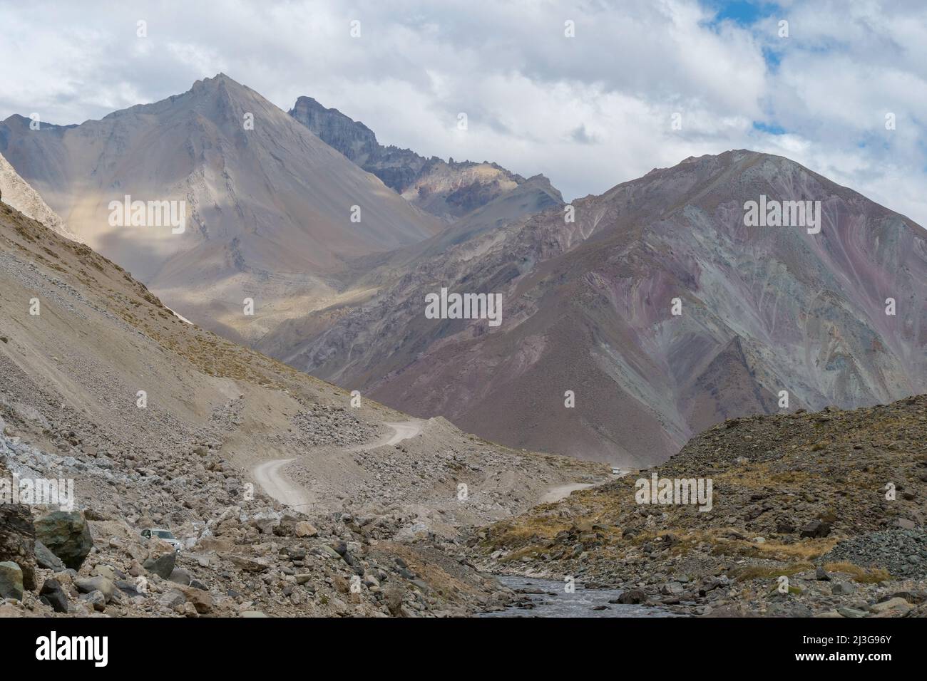 A gravel road leading through the Andes Mountain range en route to ...