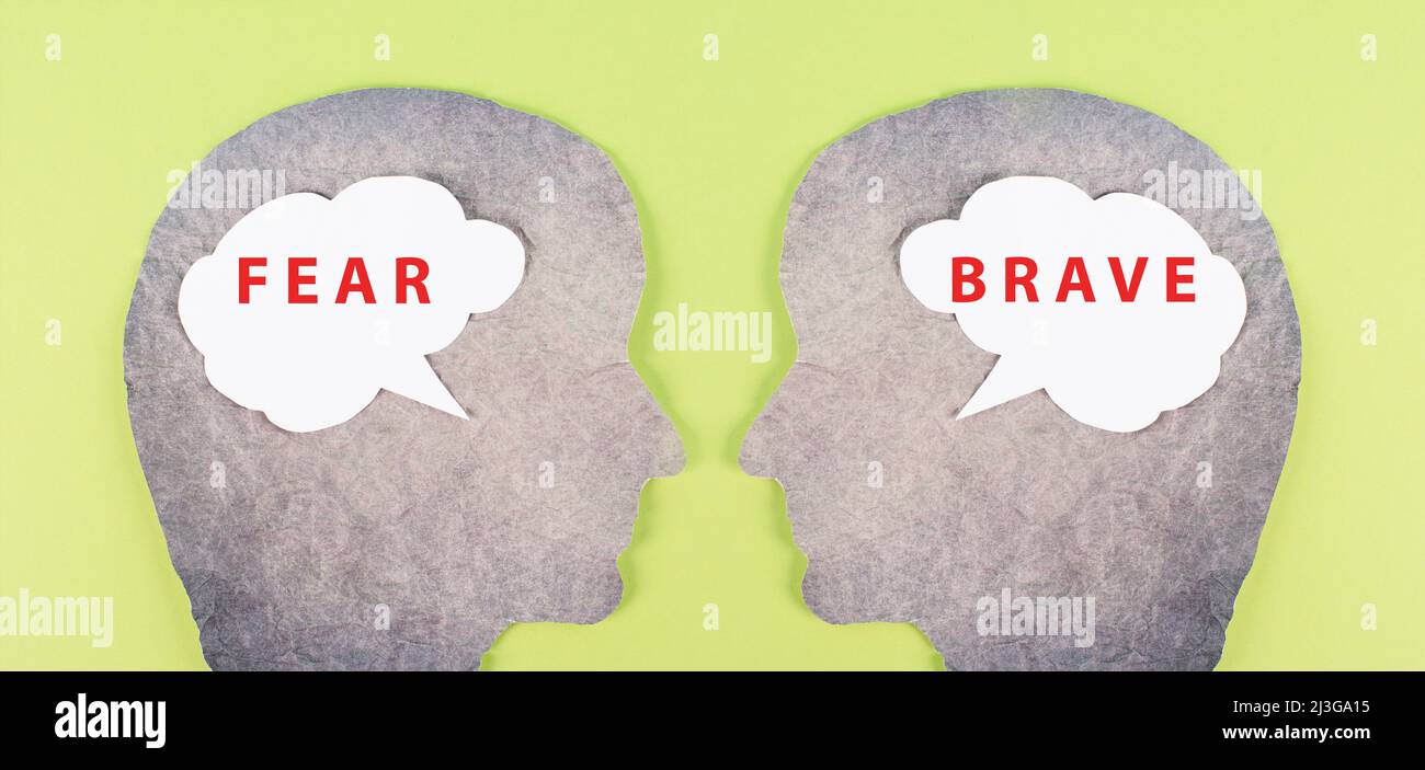 Two people look at each other, speech bubble clouds with the words fear ...