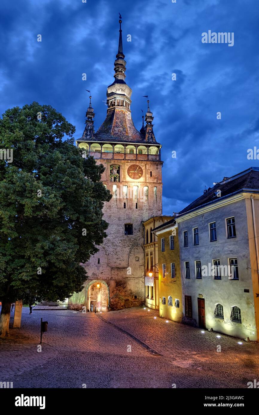 Sighisoara Clock Tower in medieval fortified town at twilight, Romania ...
