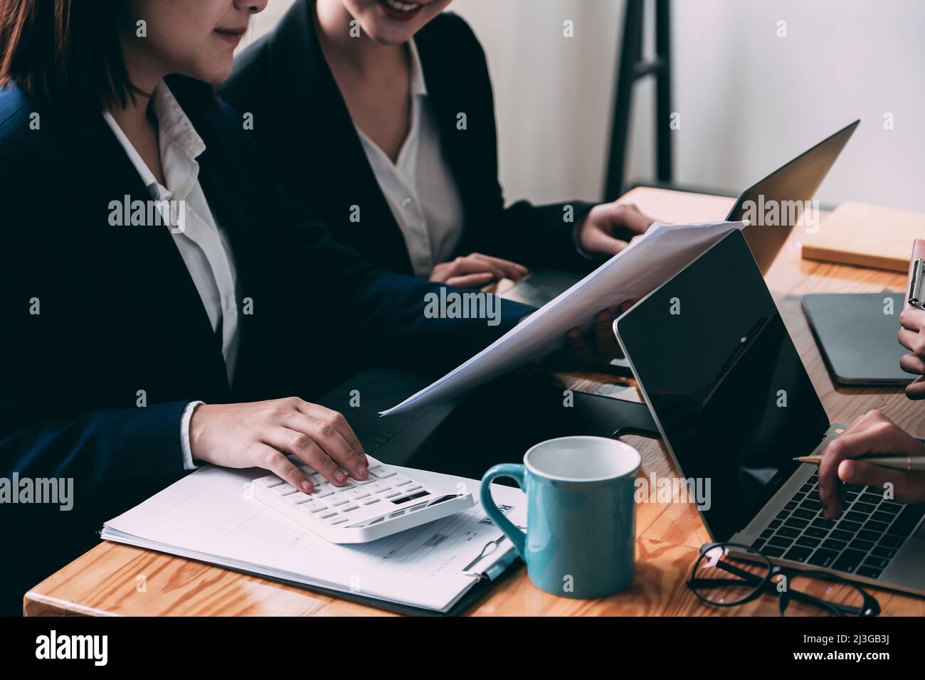 Close up Business people using calculator and laptop for calaulating ...