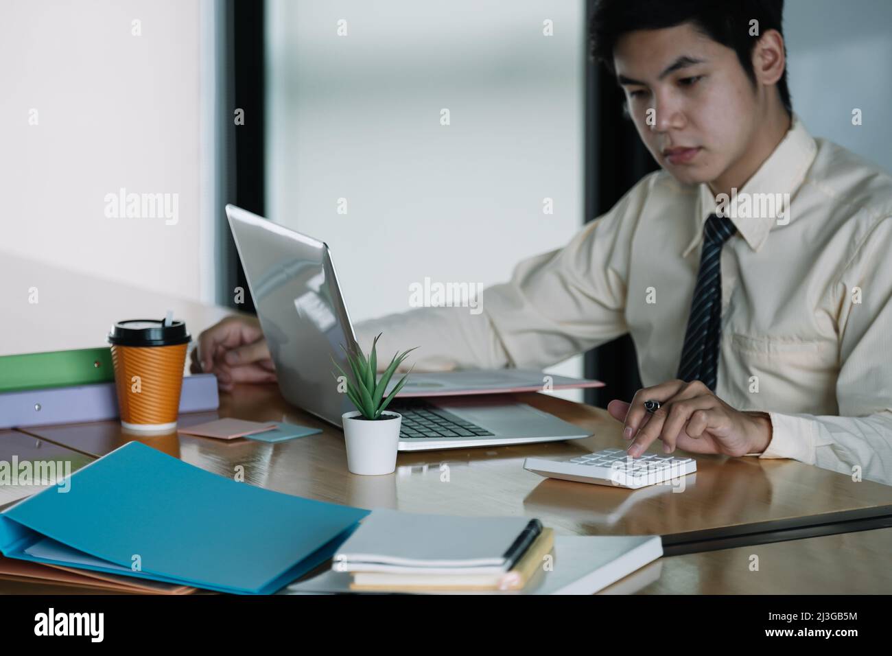 Businessman or accountant working on calculator to calculate business ...