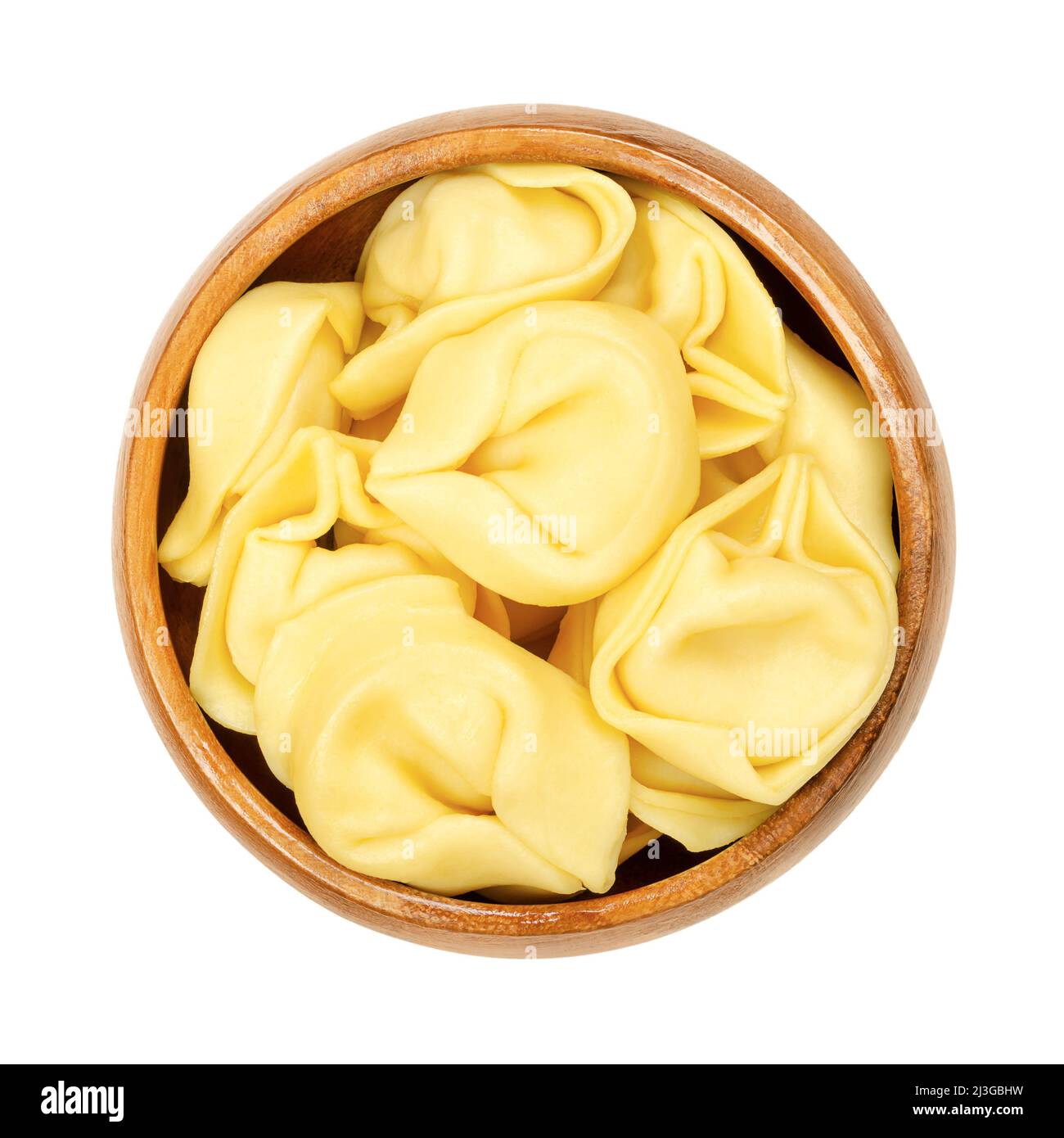 Raw tortelloni pasta in a wooden bowl. Ring-shaped stuffed Italian ...
