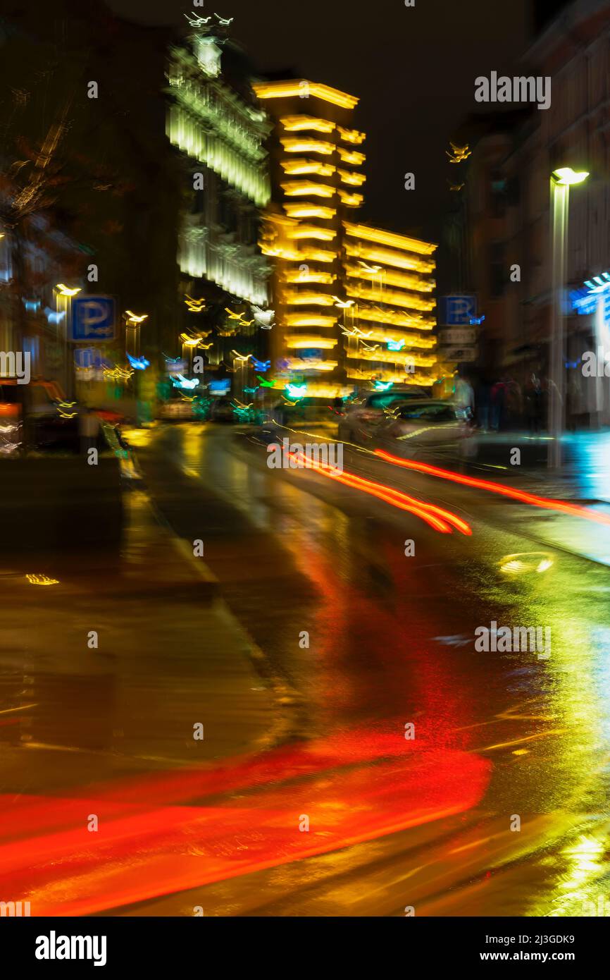 Blurred urban abstract city street, lights at night, colorful bokeh ...