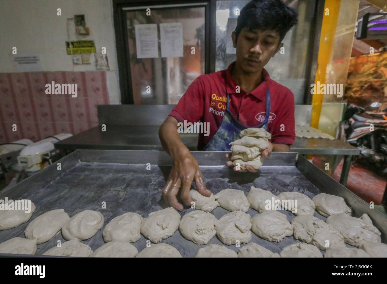 A baker prepares a traditional the Middle East known as Maryam bread or ...