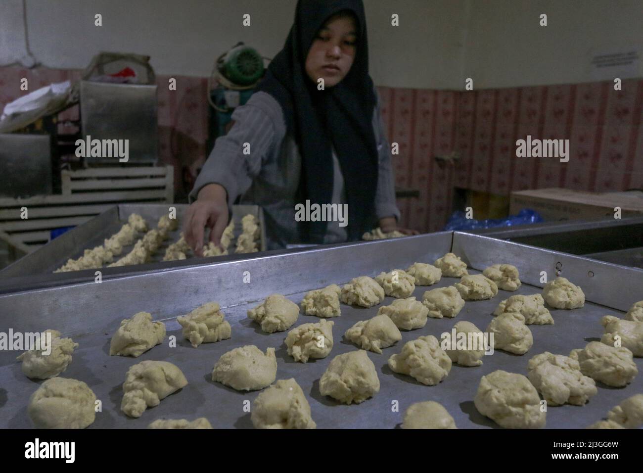A baker works on a maryam bread production in Bogor, West Java ...