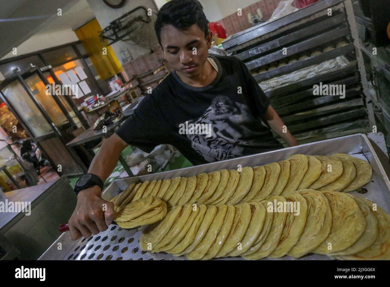 A baker prepares a traditional the Middle East known as Maryam bread or ...