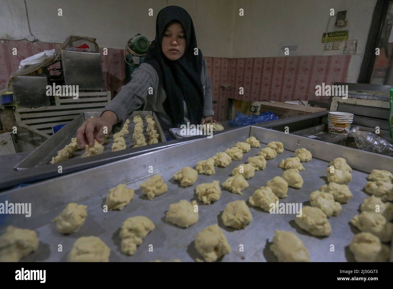 A baker prepares a traditional the Middle East known as Maryam bread or ...