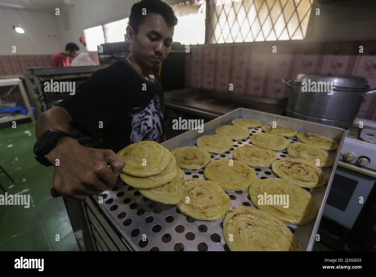 Bogor, Indonesia. 07th Apr, 2022. A baker works on a maryam bread ...
