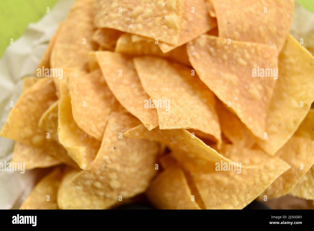 Pile of fried crisp tortilla corn chips in a basked on a table for ...