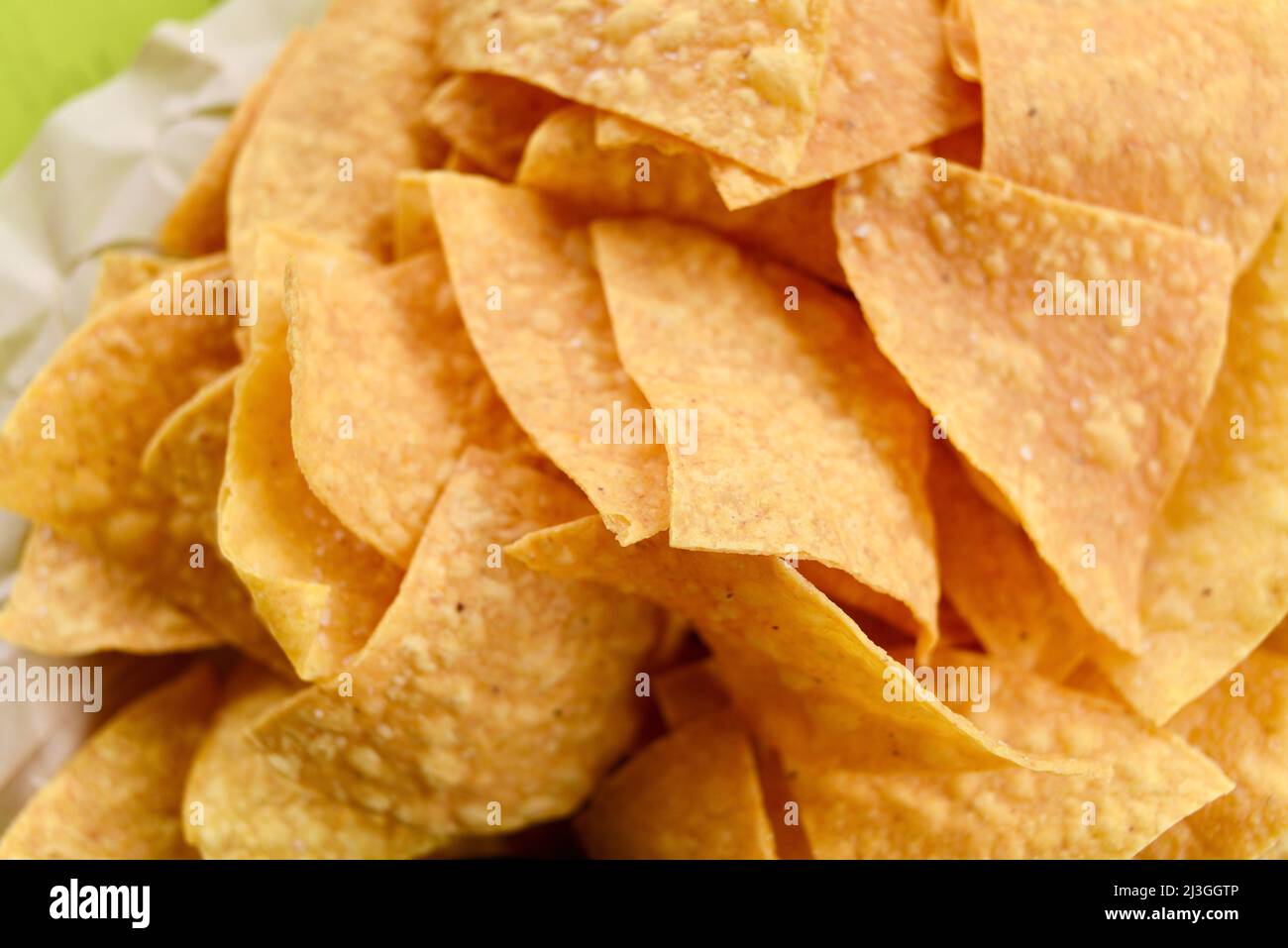 Pile of fried crisp tortilla corn chips in a basked on a table for ...