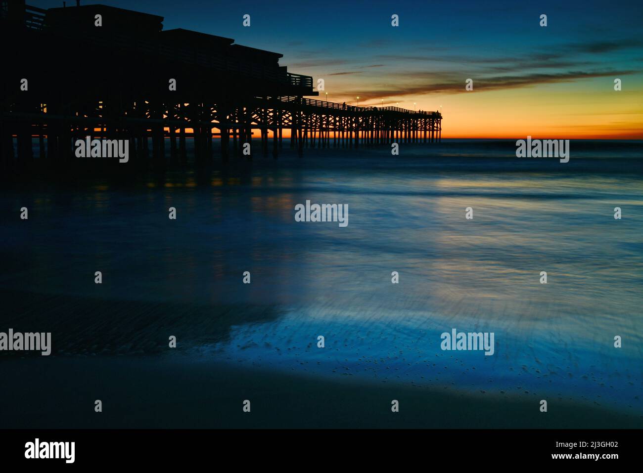 Dramatic sunset with surf waves breaking at Crystal Pier and Crystal ...
