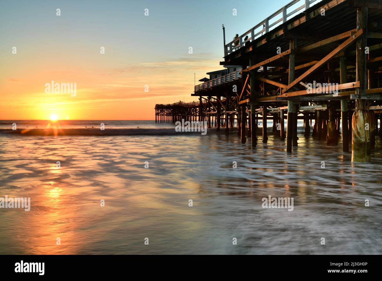 Dramatic sunset with surf waves breaking at Crystal Pier and Crystal ...