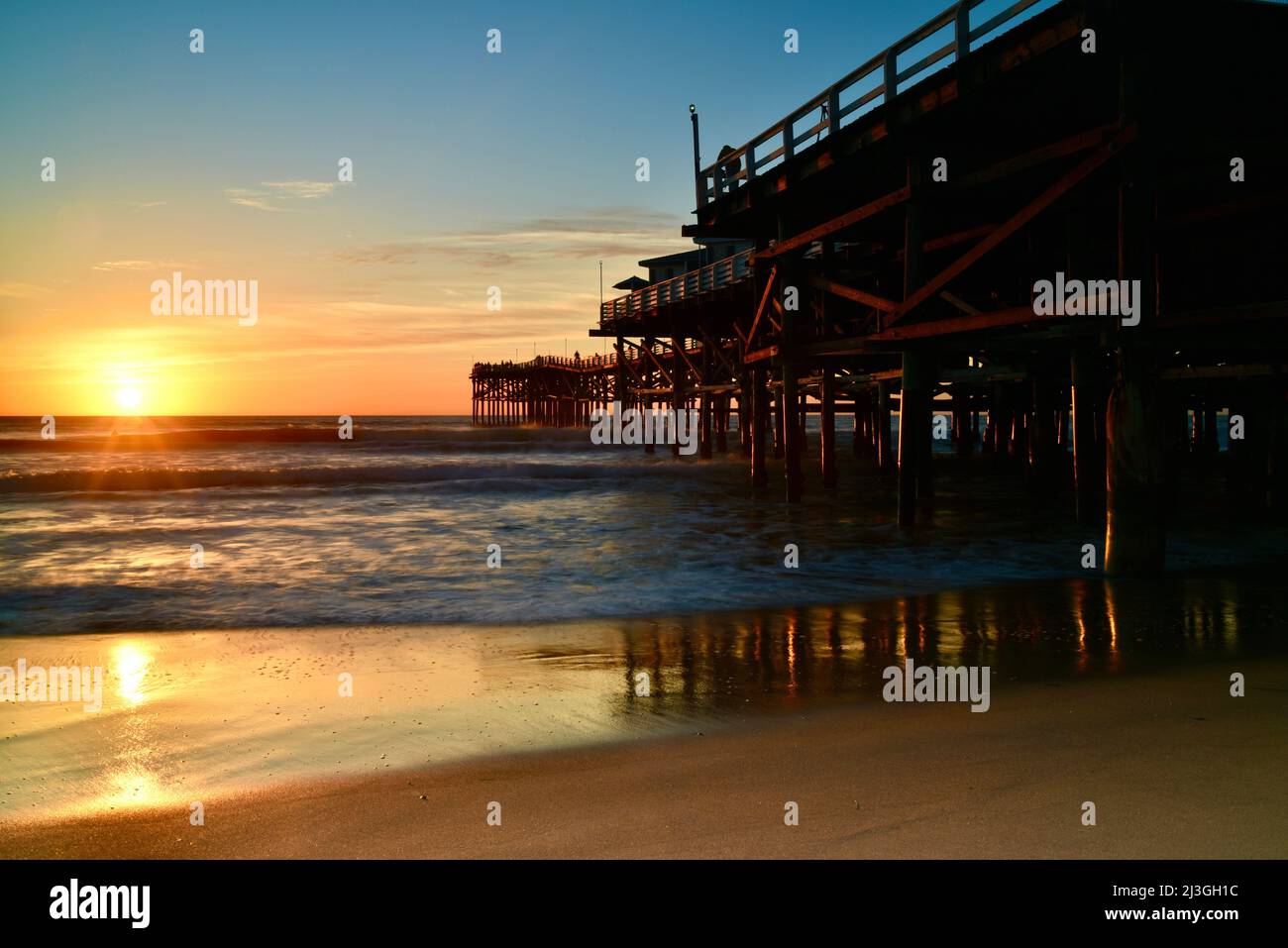 Dramatic sunset with surf waves breaking at Crystal Pier and Crystal ...