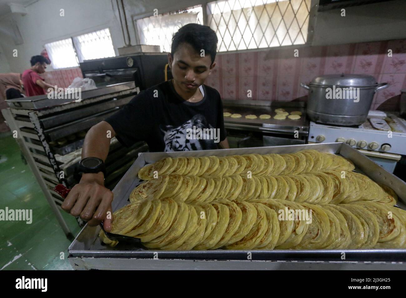 A baker prepares a traditional the Middle East known as Maryam bread or ...